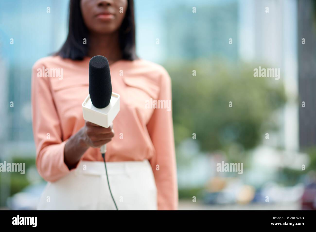 African journalist holding microphone hi-res stock photography and ...