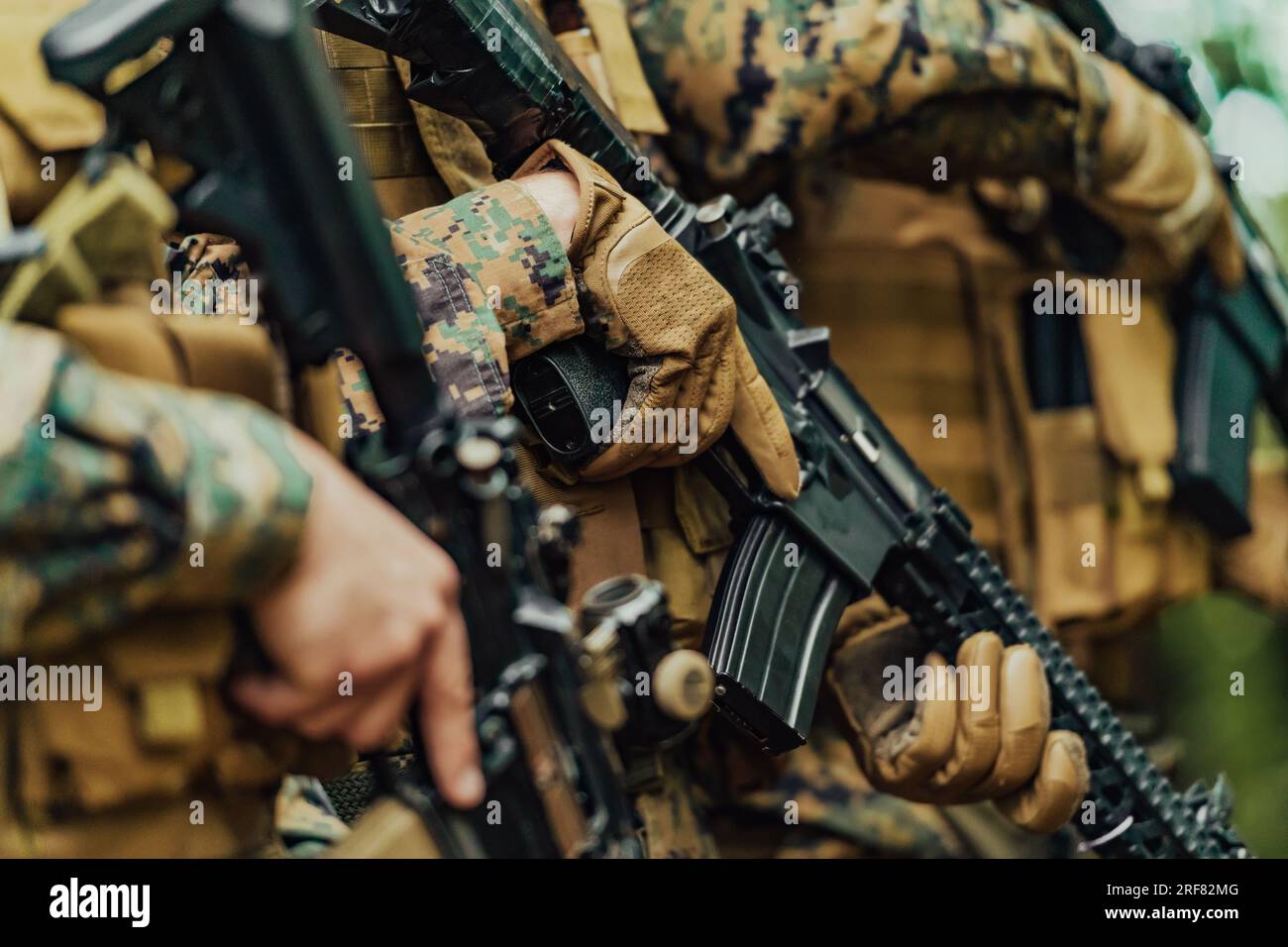 Soldier fighters standing together with guns. Group portrait of US army ...