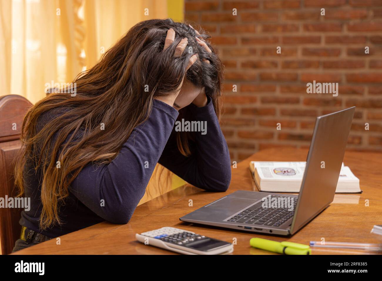 Stressed latin girl, studying in front of a laptop Stock Photo - Alamy