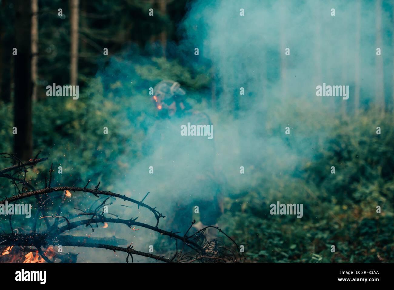 A soldier fights in a warforest area surrounded by fire Stock Photo - Alamy