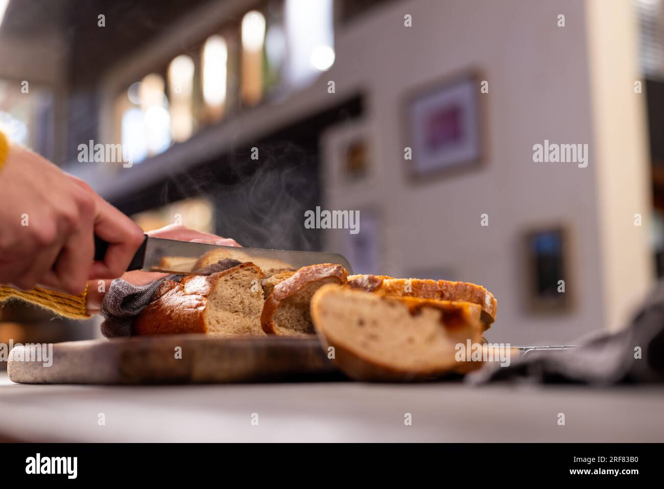 Hands cutting bread hi-res stock photography and images - Alamy