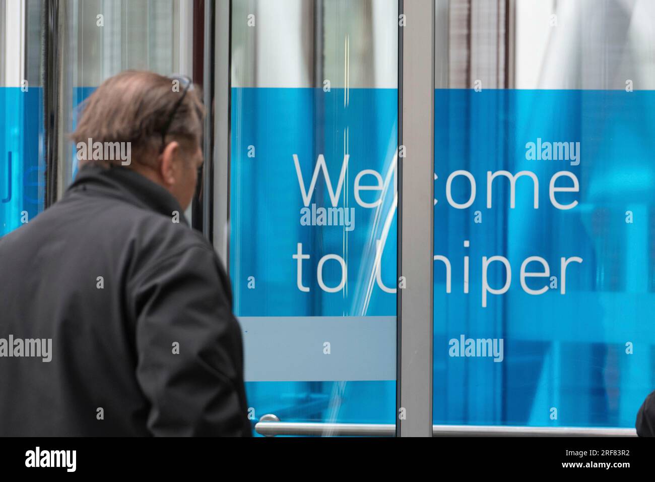 People walk through a revolving door of the Uniper corporate ...