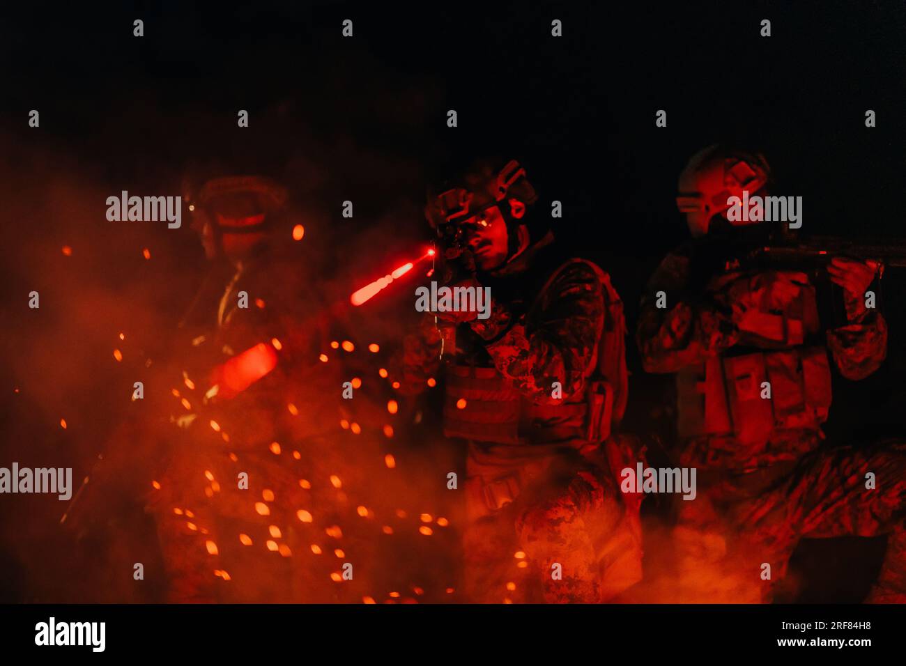 Soldiers squad in action on night mission using laser sight beam lights ...