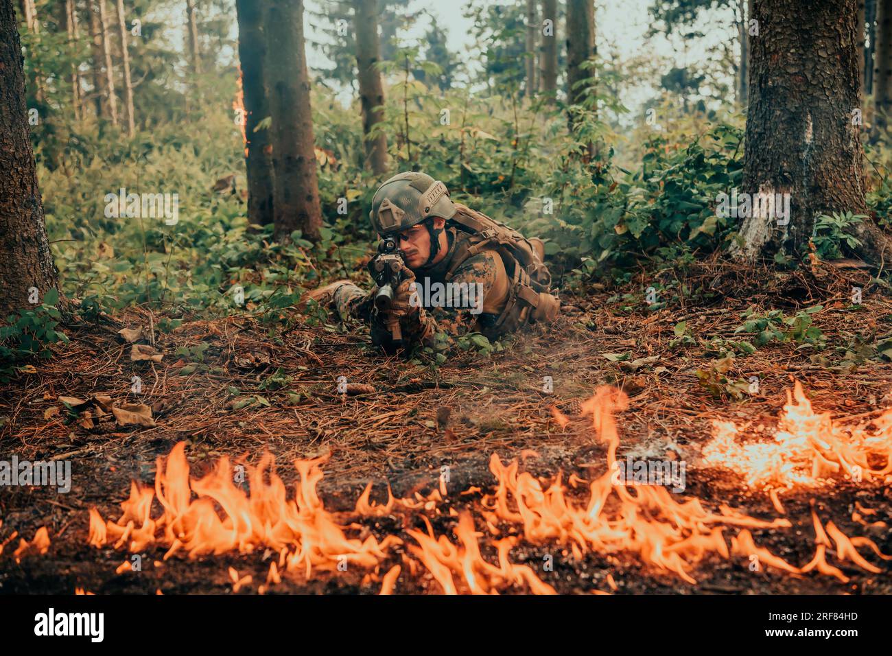 Modern warfare soldier surrounded by fire, fight in dense and dangerous ...