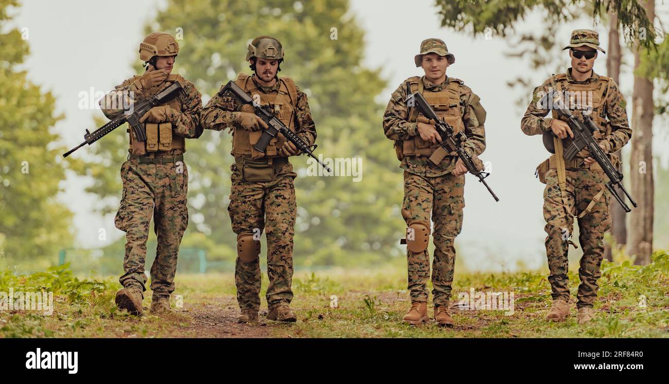 Soldier fighters standing together with guns. Group portrait of US army ...