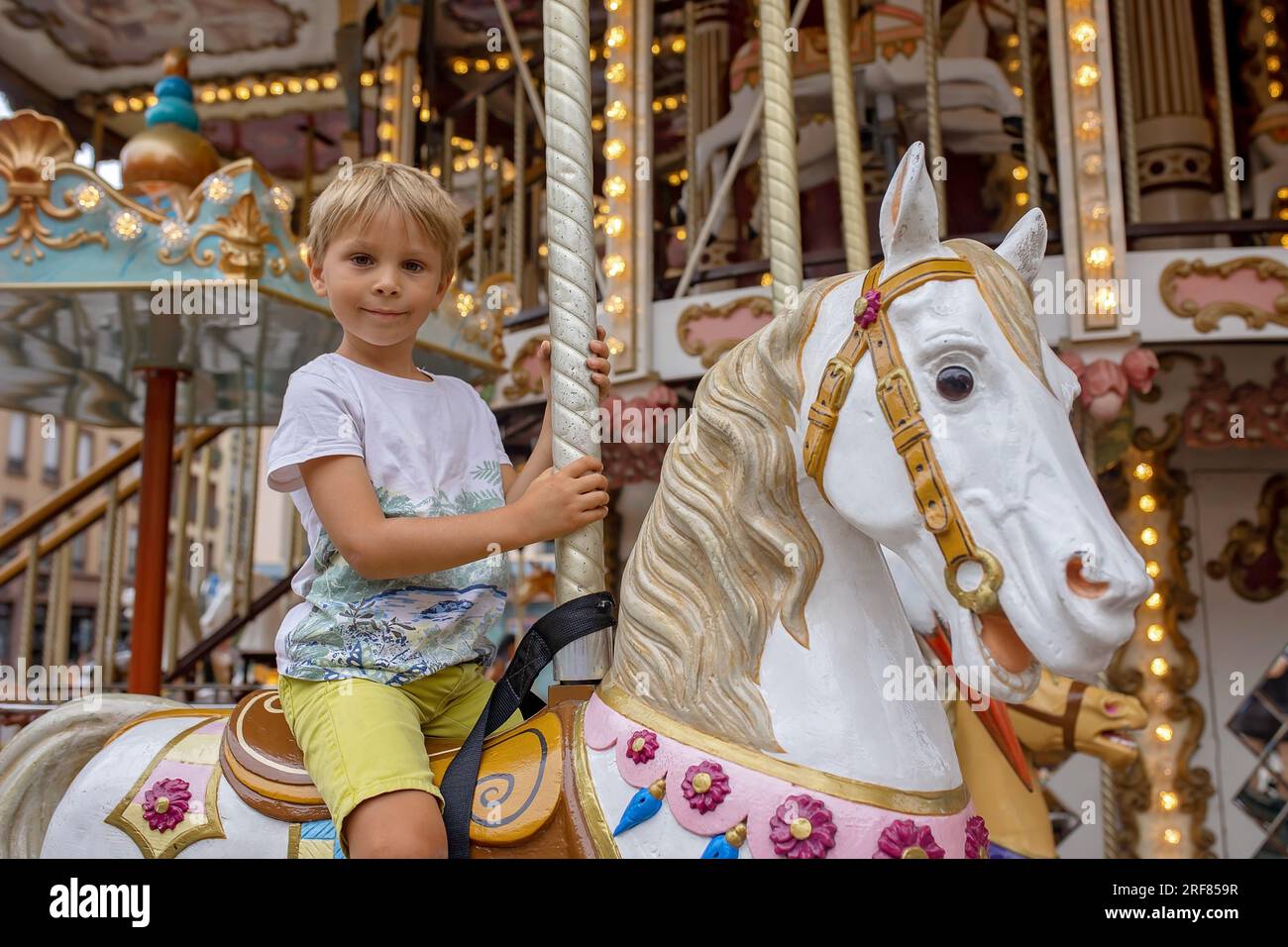 Children, boys, going on Merry Go Round, kids play on carousel ...