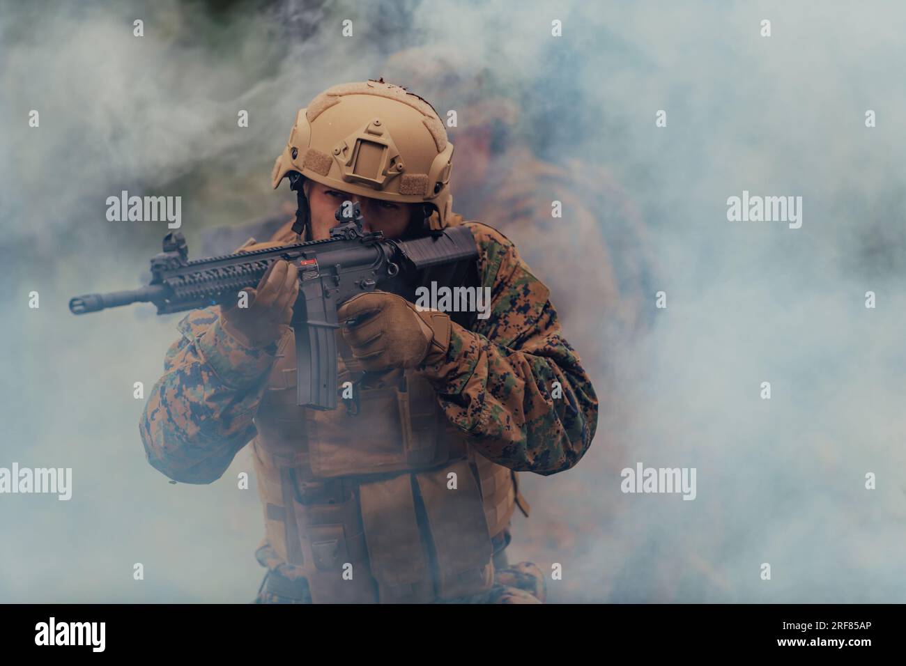 A soldier fights in a warforest area surrounded by fire Stock Photo - Alamy