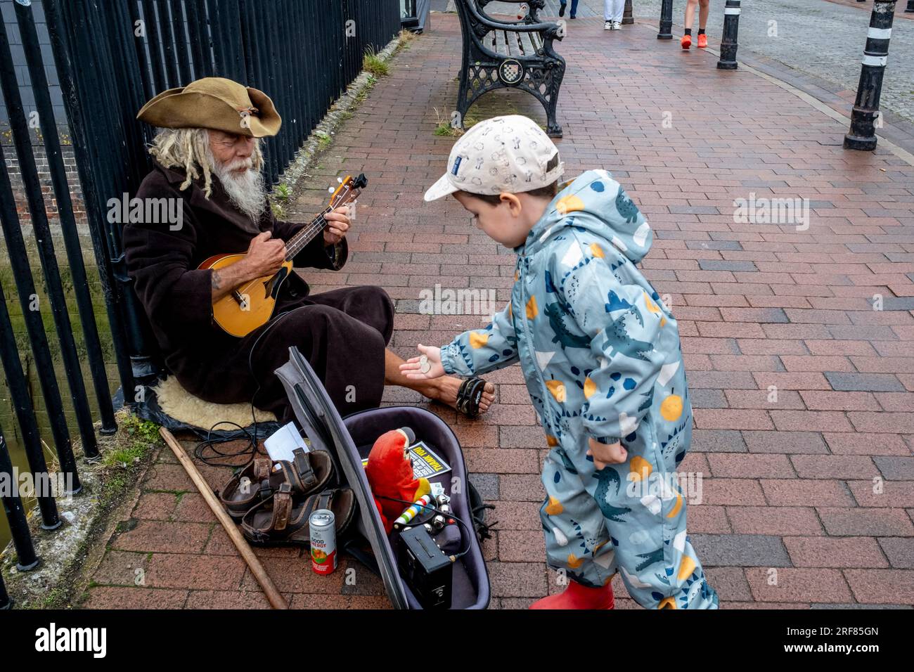 A Little Boy Gives Money To A Street Entertainer, High Street, Lewes ...