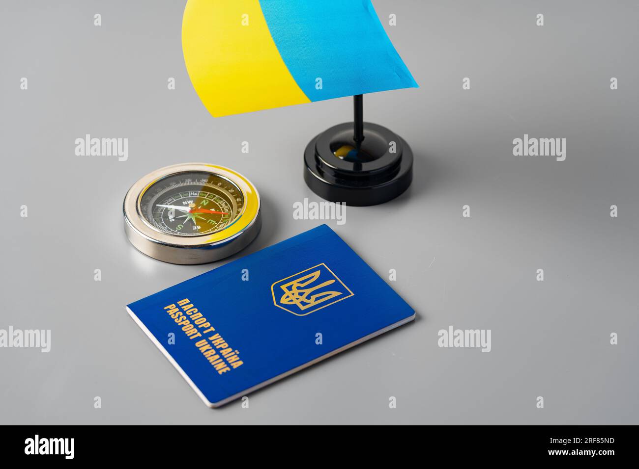 Ukrainian flag, Ukrainian passport and compass on gray table Stock ...