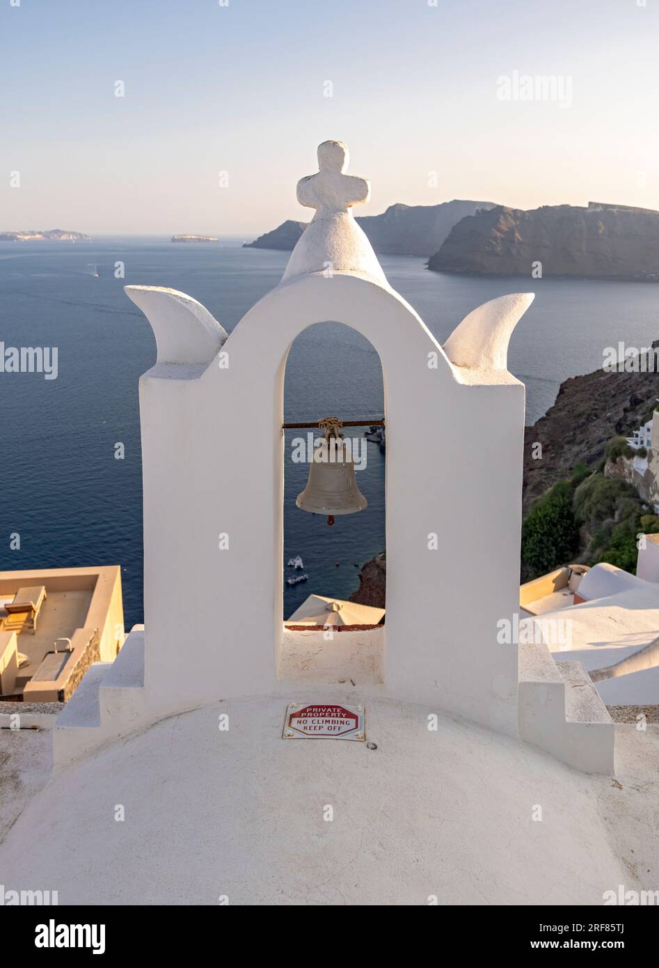 Whitewashed bell-tower wiith a view of caldera and sea, Ia (Oia ...