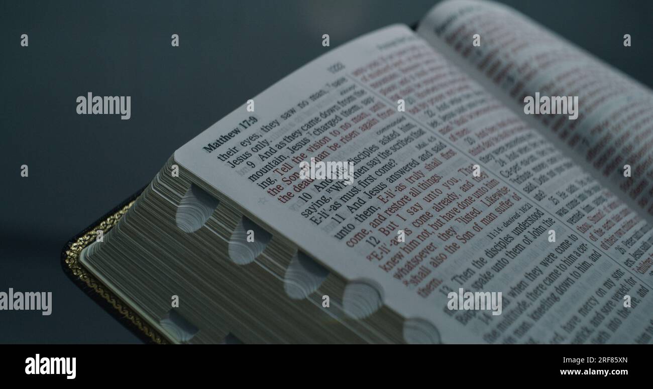 African American prisoner in orange uniform reads Bible in prison cell ...