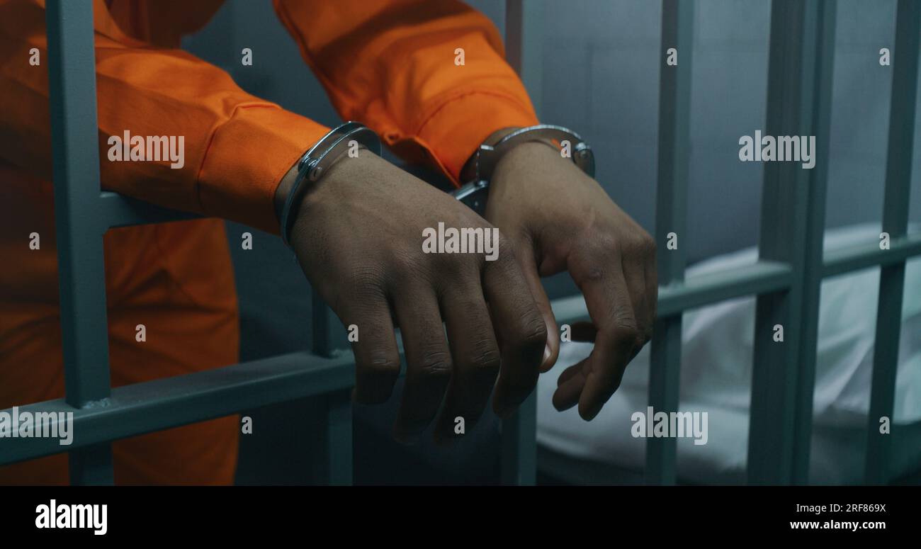 African hands prison bars hi-res stock photography and images - Alamy
