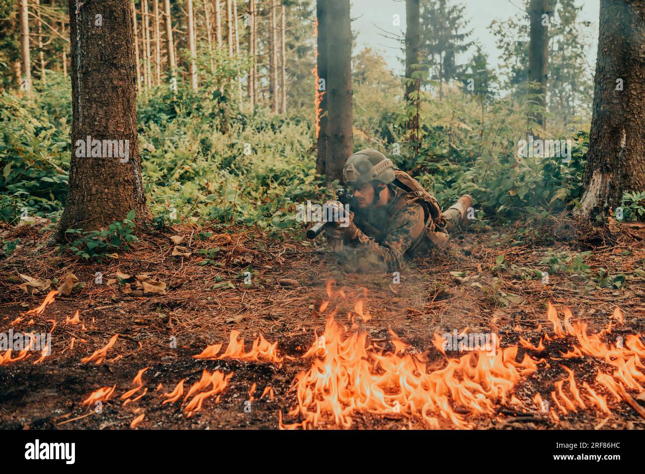 Modern warfare soldier surrounded by fire, fight in dense and dangerous ...