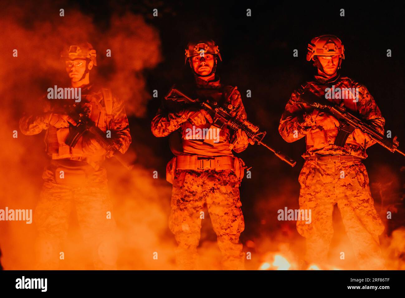 Soldiers squad in action on night mission using laser sight beam lights ...