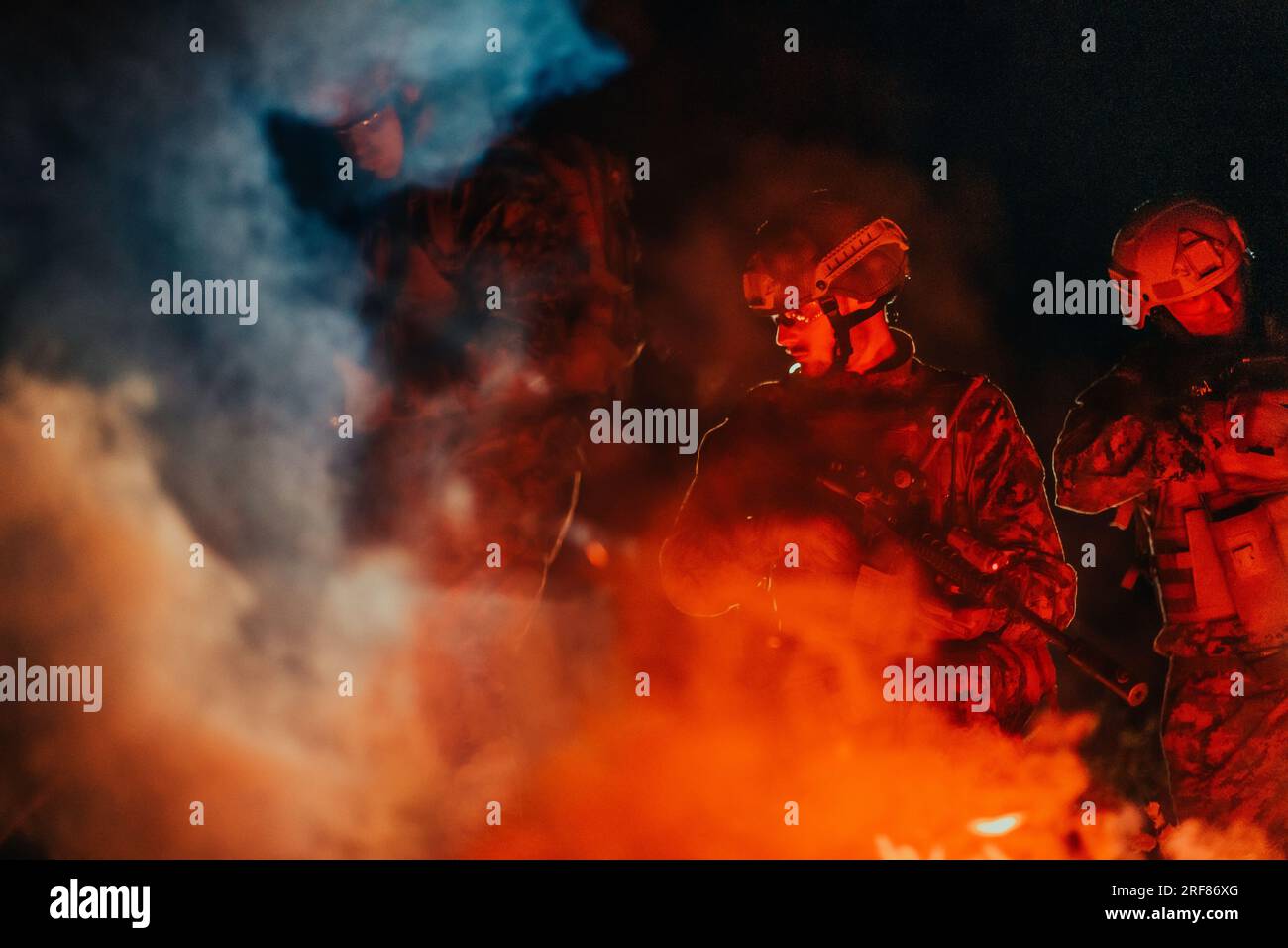 Soldiers squad in action on night mission using laser sight beam lights ...