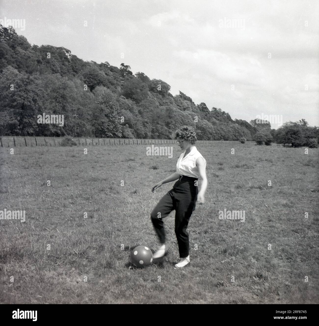 1950s, historical, summertime and a young women wearing slacks and ...