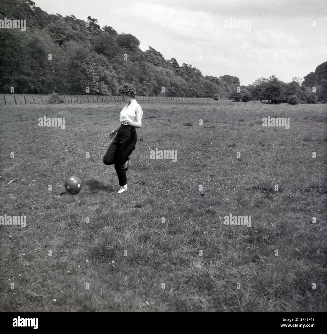 1950s, historical, summertime and a young women wearing slacks and ...