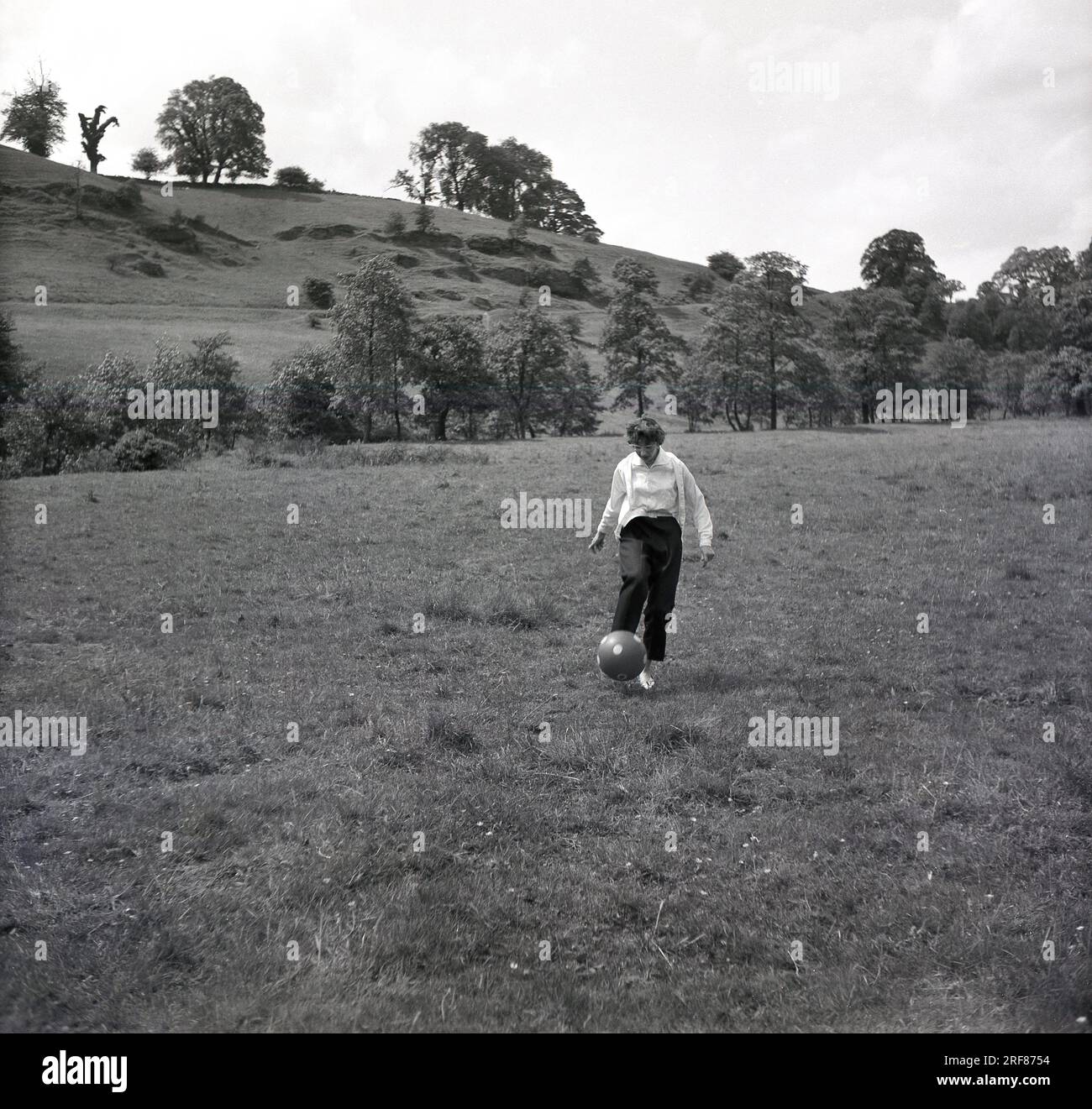 1950s, historical, summertime and a young women wearing slacks and a ...