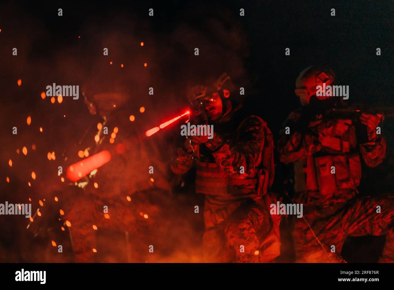 Soldiers squad in action on night mission using laser sight beam lights ...