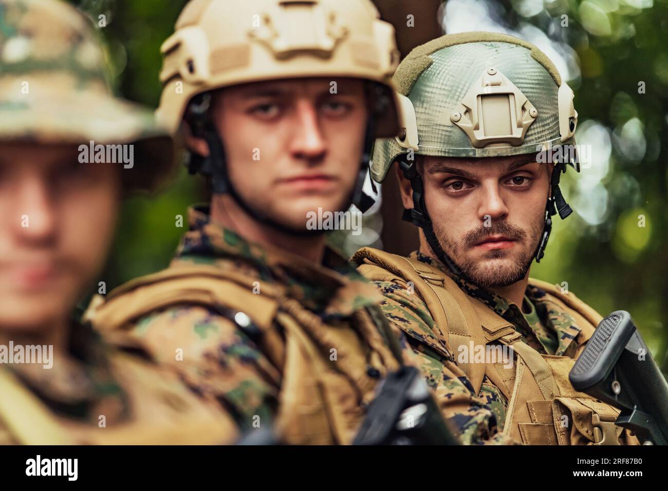 Soldier fighters standing together with guns. Group portrait of US army ...