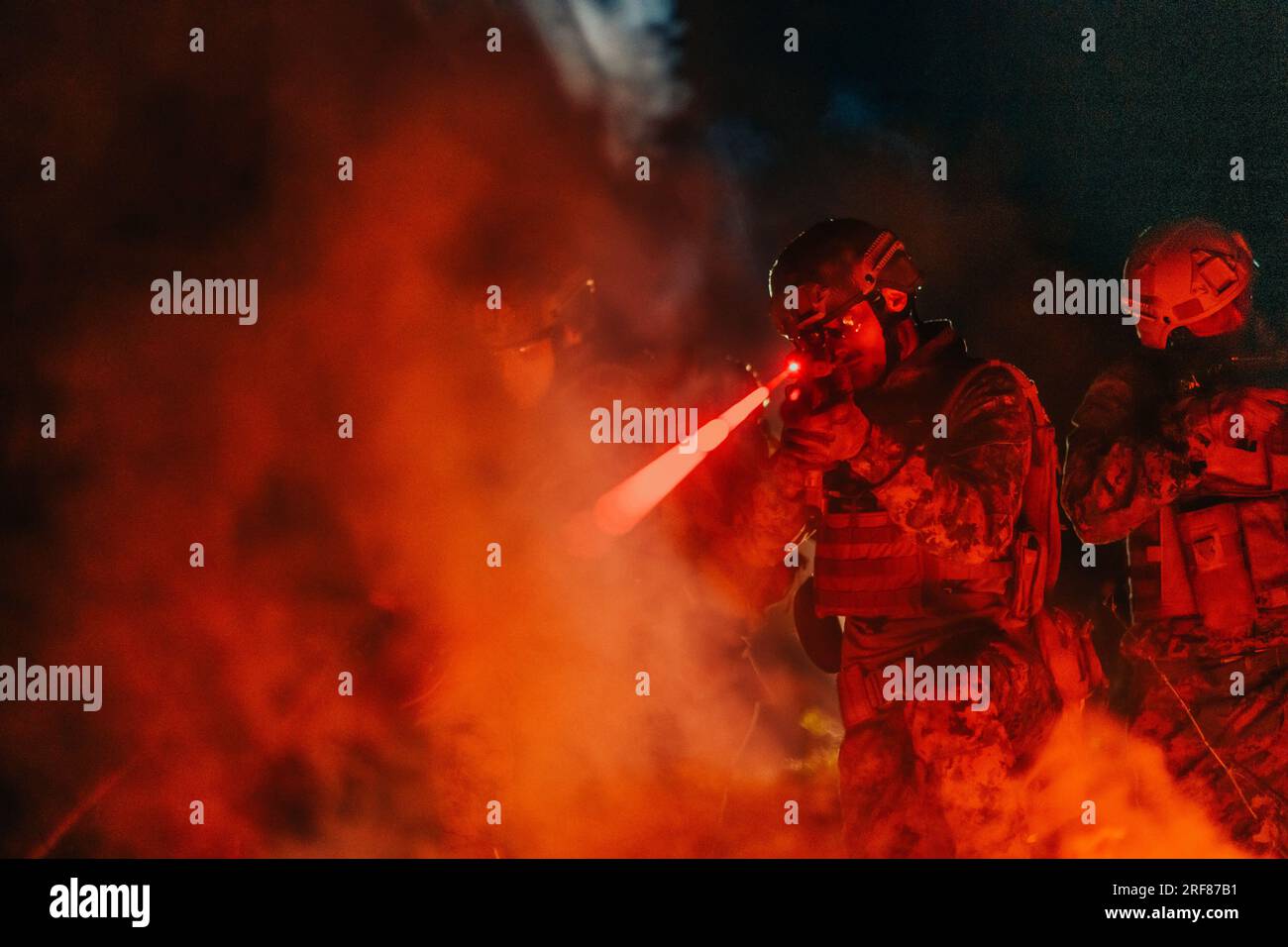 Soldiers squad in action on night mission using laser sight beam lights ...