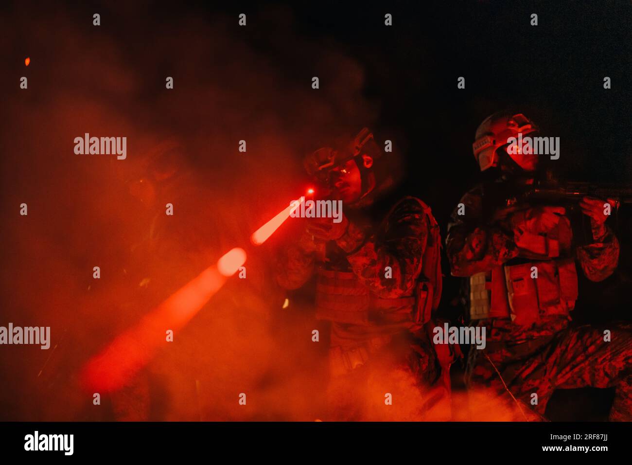 Soldiers squad in action on night mission using laser sight beam lights ...
