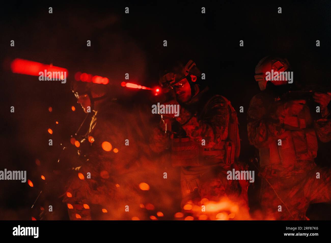 Soldiers squad in action on night mission using laser sight beam lights ...