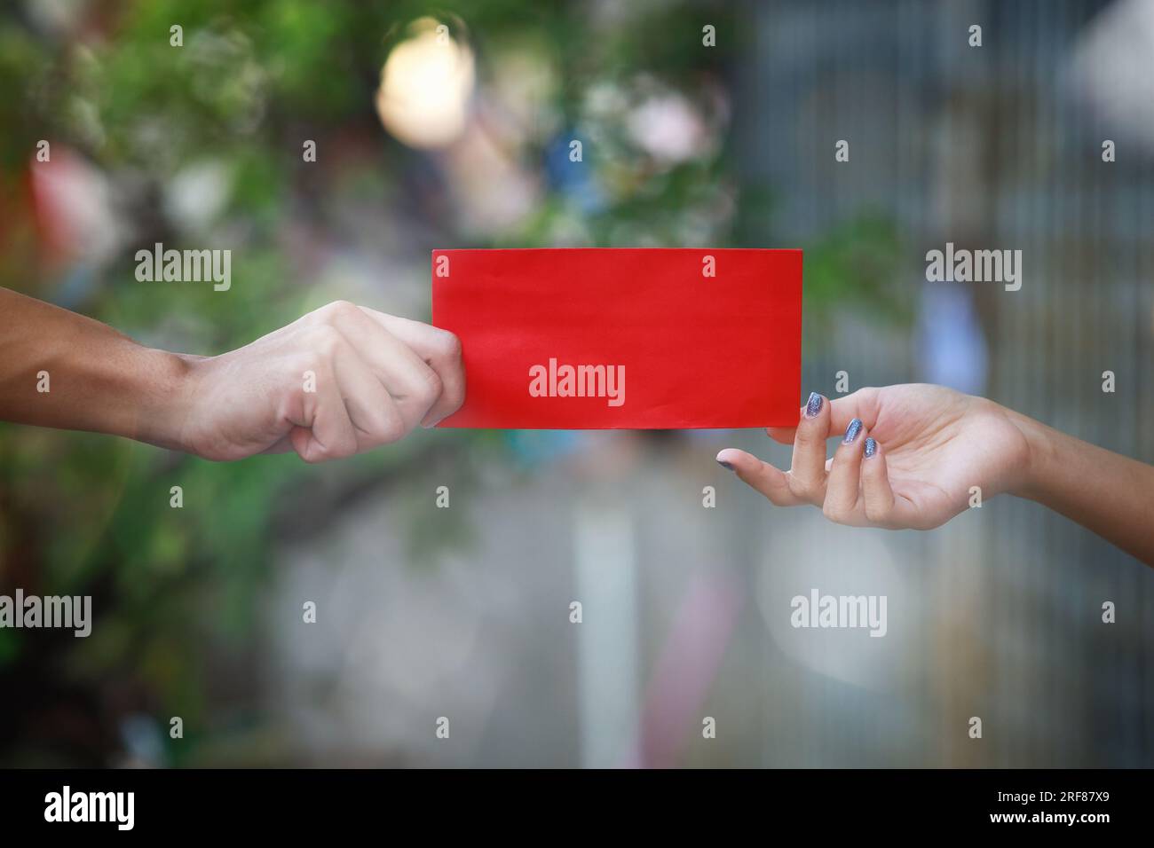 The elders hand give red envelope "Ang pao" to their children and ...