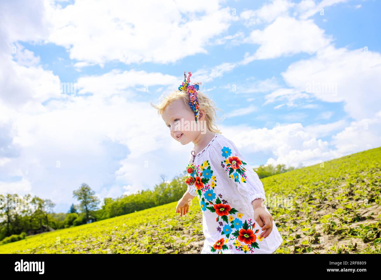 Happy Ukrainian child in free Ukraine without war runs along a rural ...