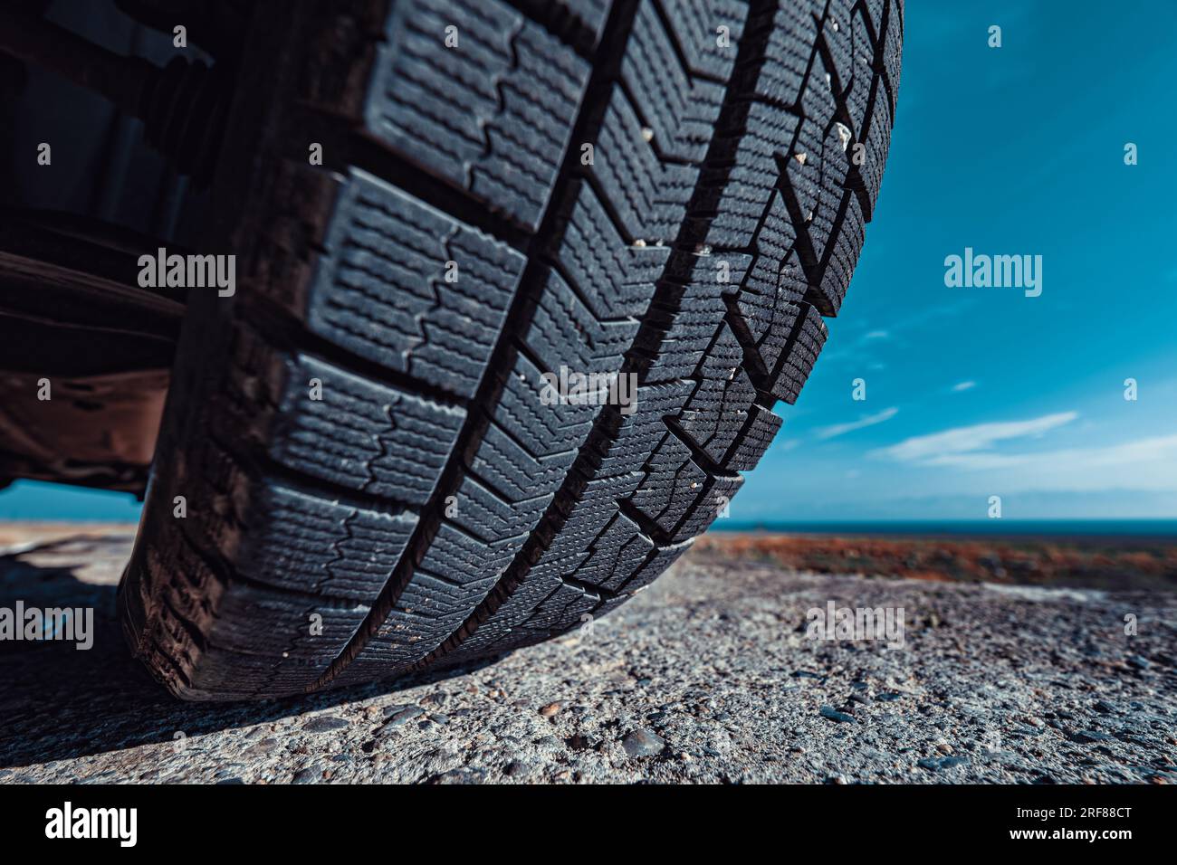 Car tire on stone close-up view Stock Photo - Alamy