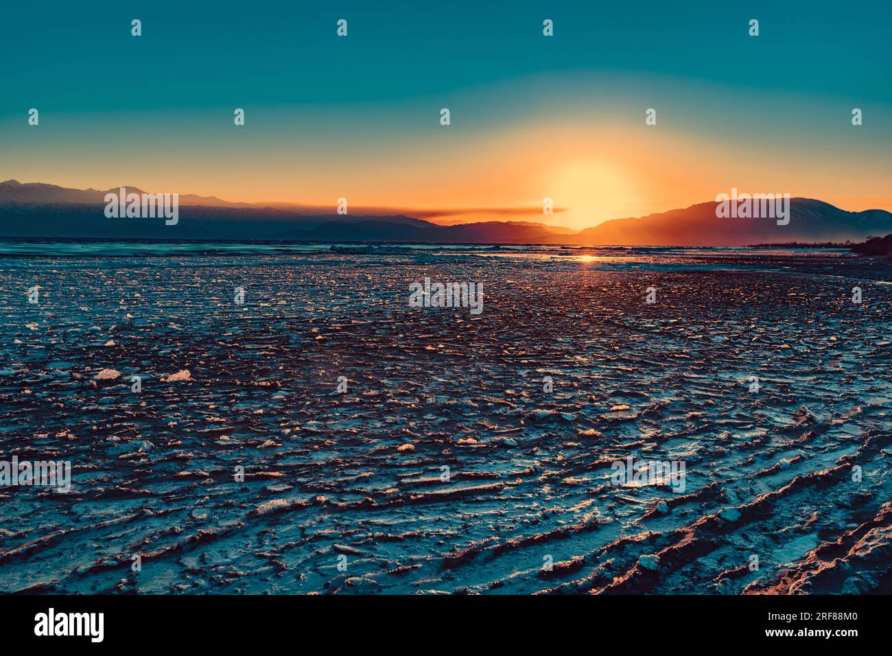 Frozen water in lake at cold winter weather, sunset light, Kyrgyzstan ...