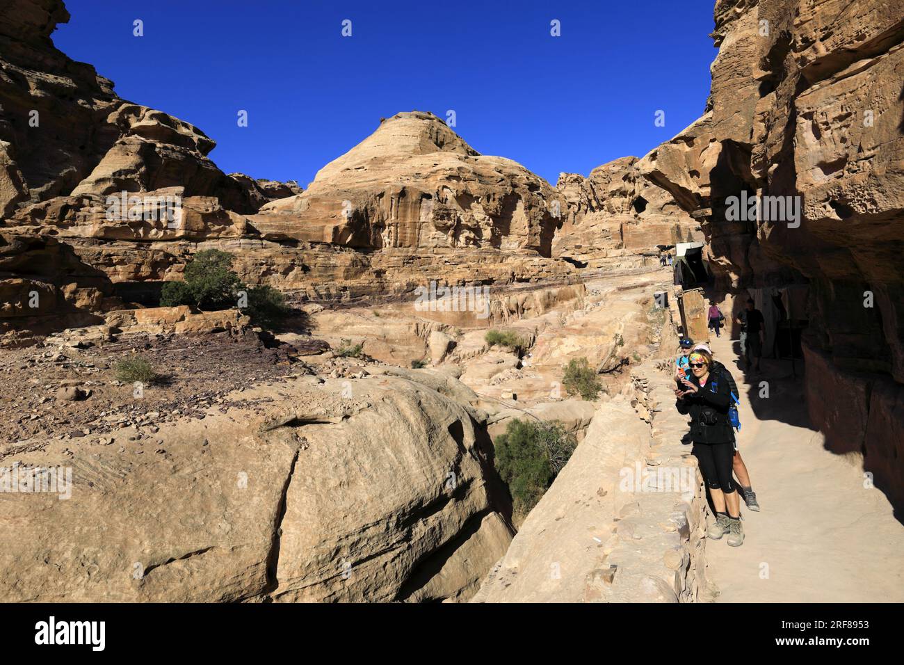 People on the Ad Deir Monastery trail down to Petra city, UNESCO World ...