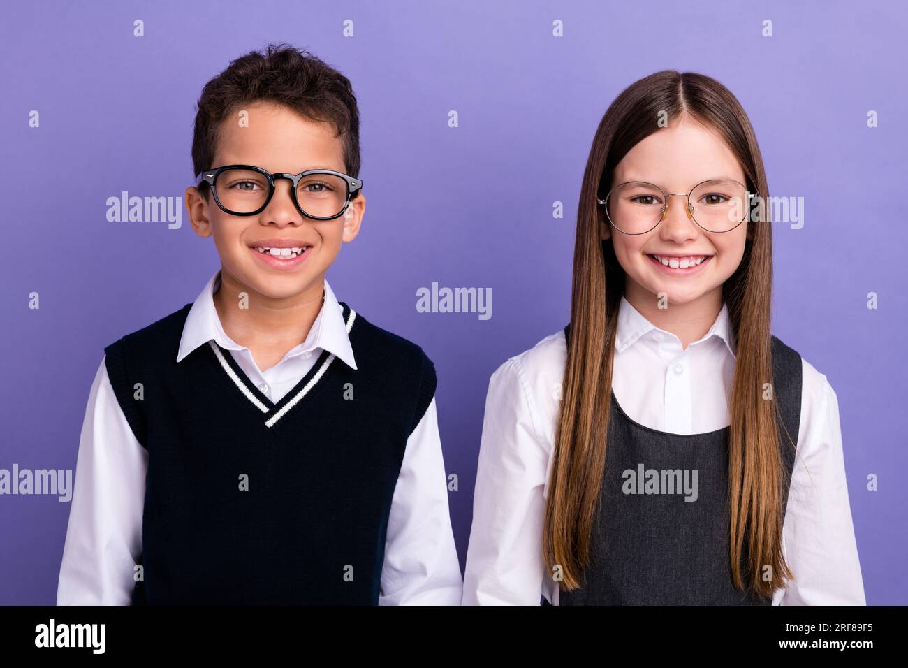 Photo of two smart pupils ready for learning interesting information ...