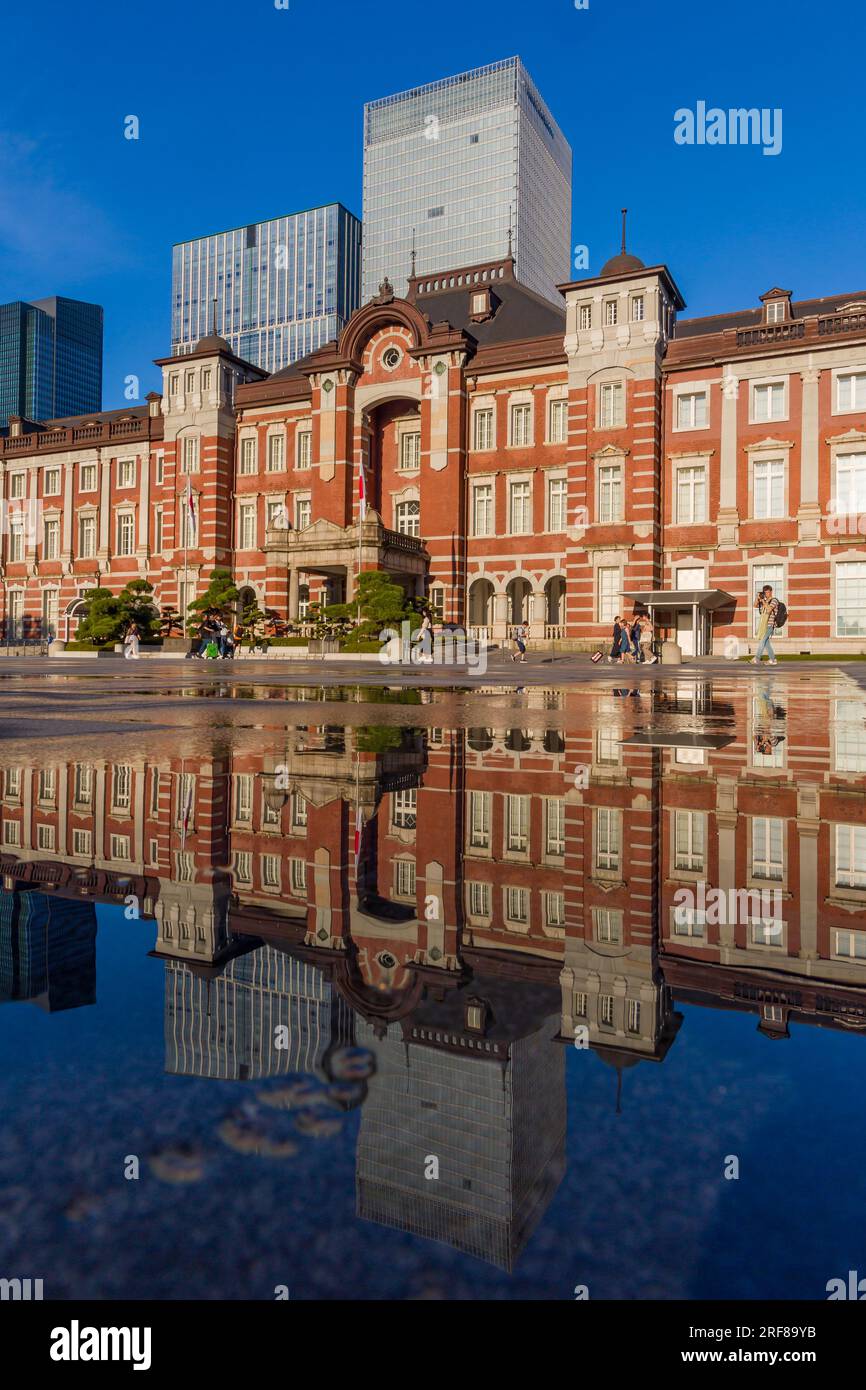 TOKYO, JAPAN - JULY 30 2023: Reflection of Tokyo Station in water ...
