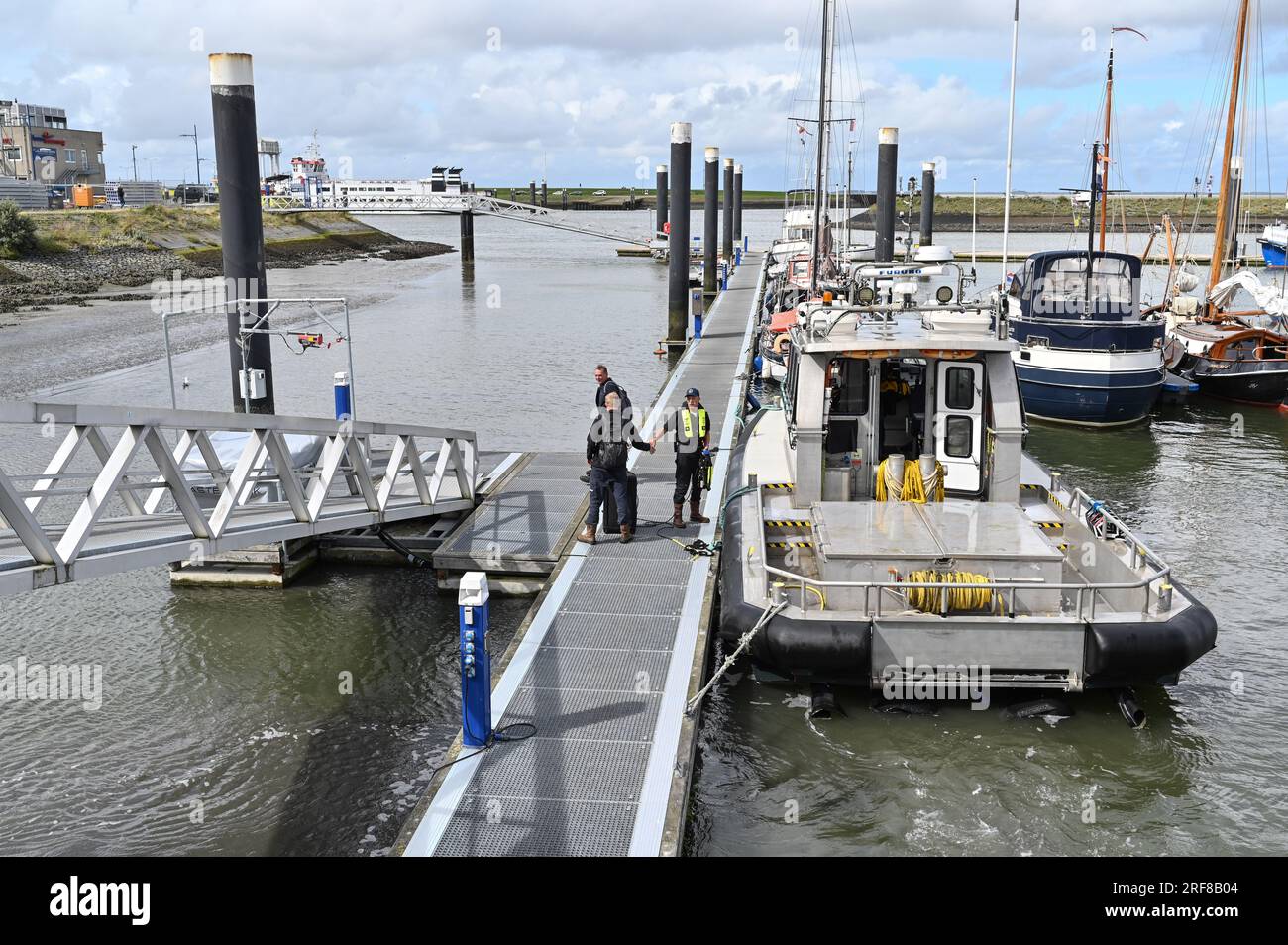 Lauwersoog, Netherlands. 01st Aug, 2023. Two crew members from the ...