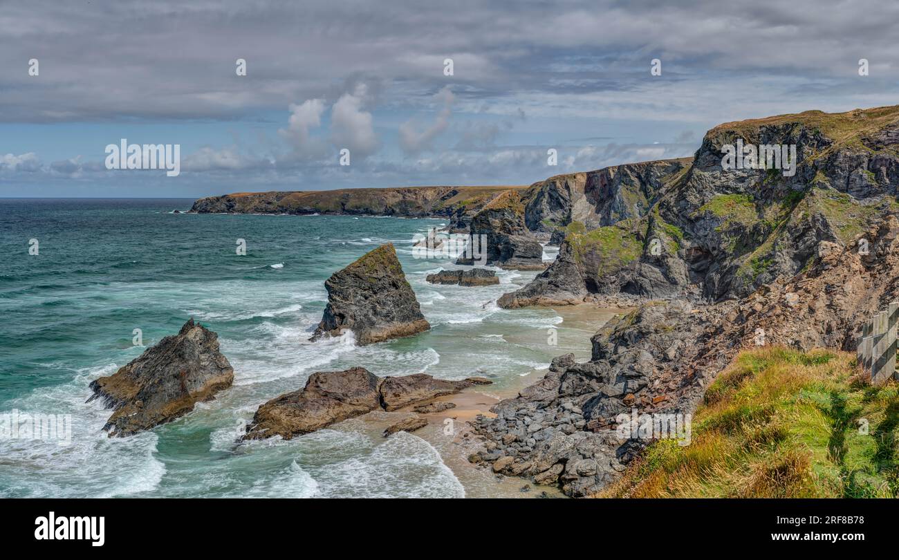 A panoramic landscape showing high tide covering a sandy Bedruthan ...