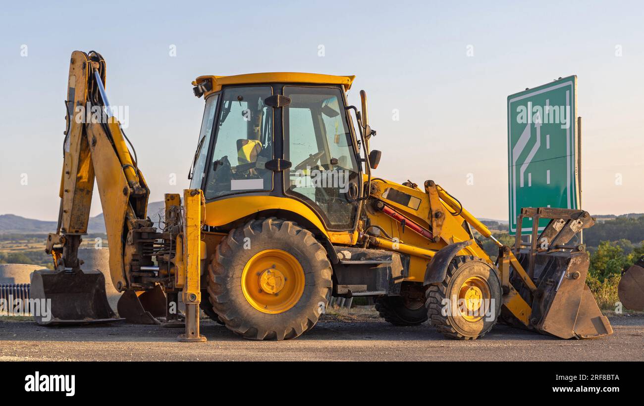 Backhoe Loader Machine at Highway Construction Site Stock Photo - Alamy