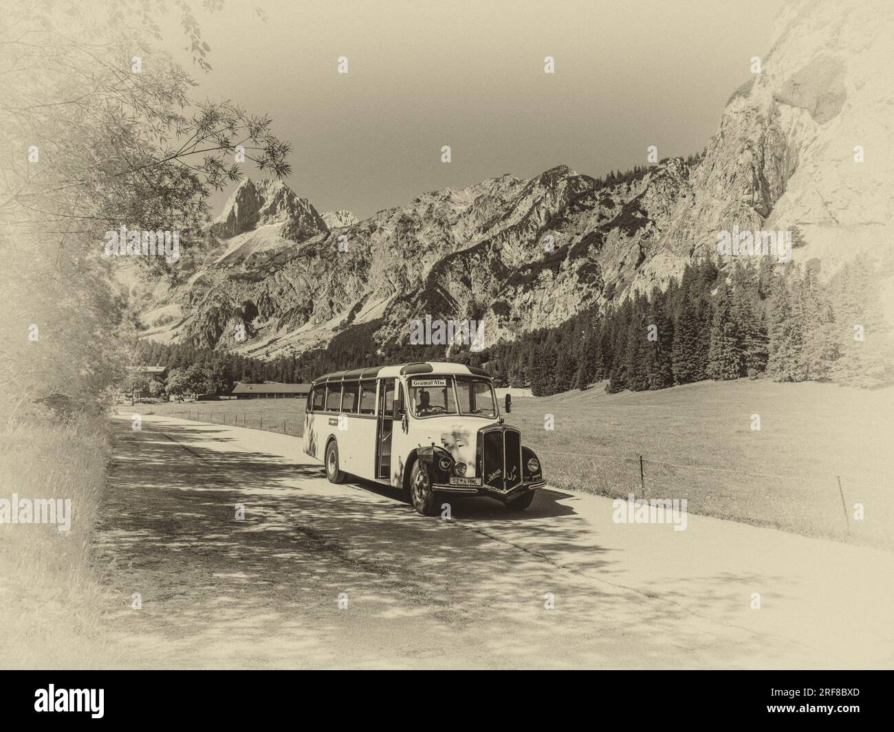 Nostalgic 1930's Gramai Alm passenger coach passing through the ...