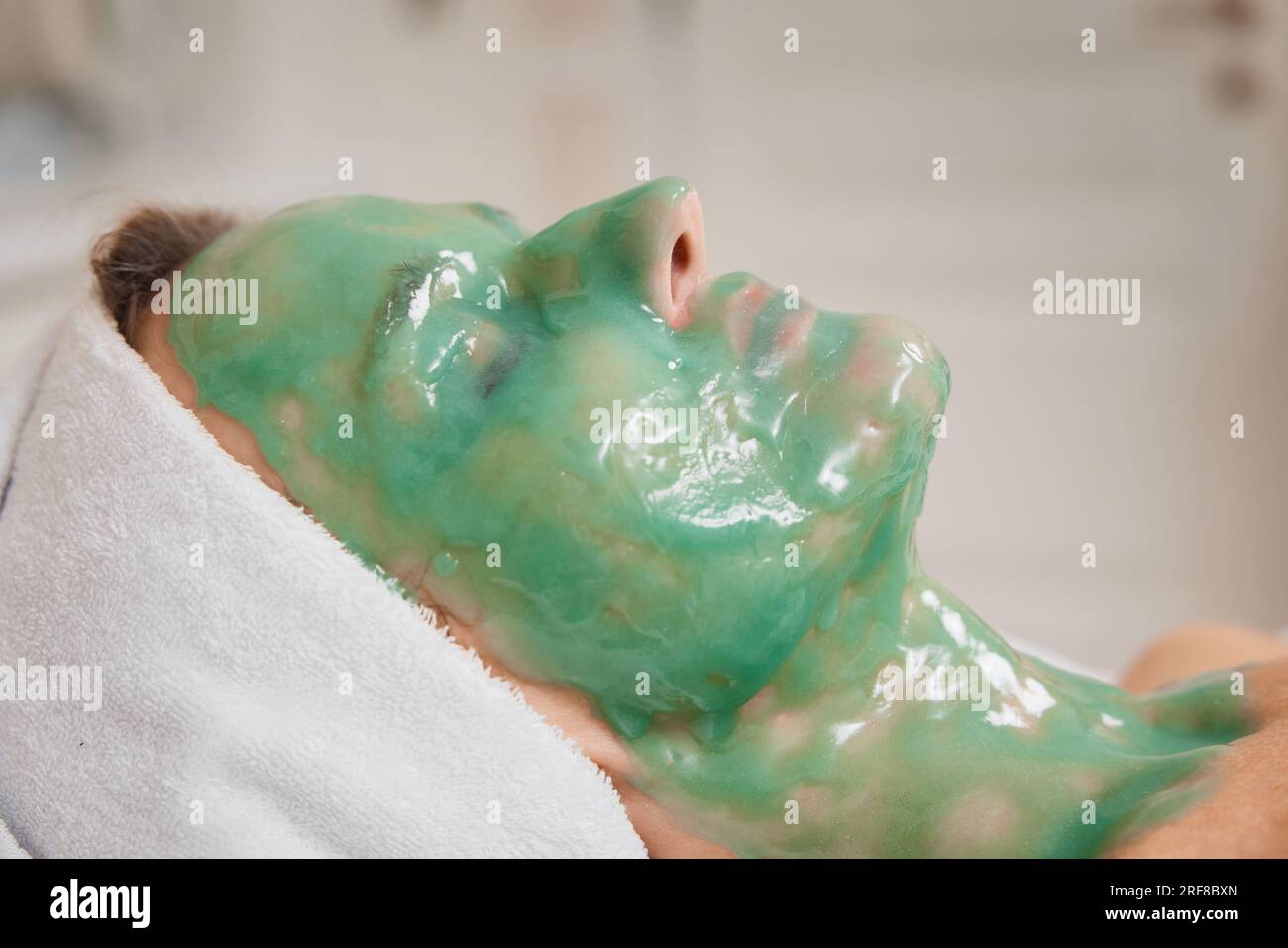 beautiful woman with green alginate mask on face Stock Photo - Alamy