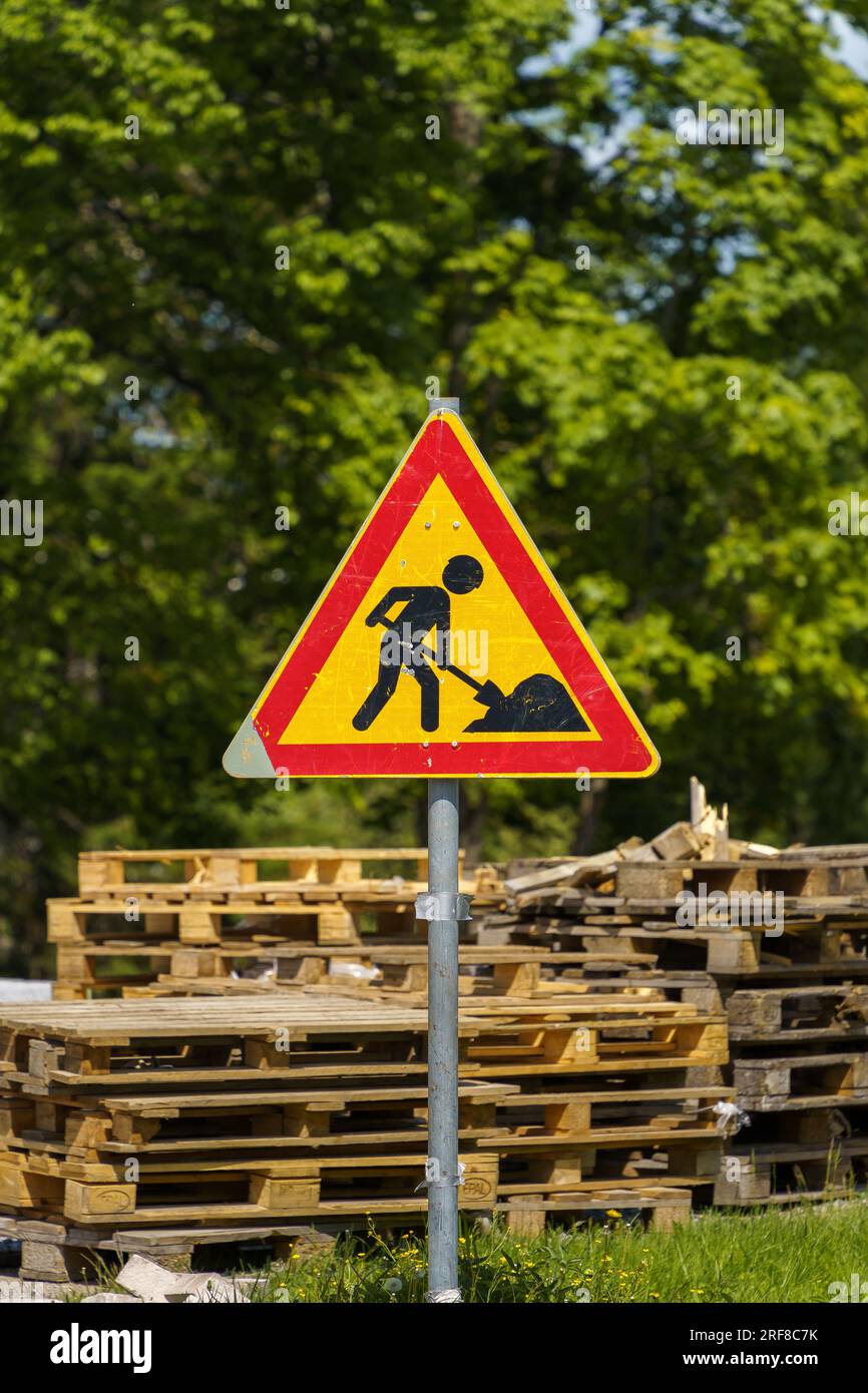 Roadworks warning sign in summer with wooden pallets in the background Stock Photo - Alamy