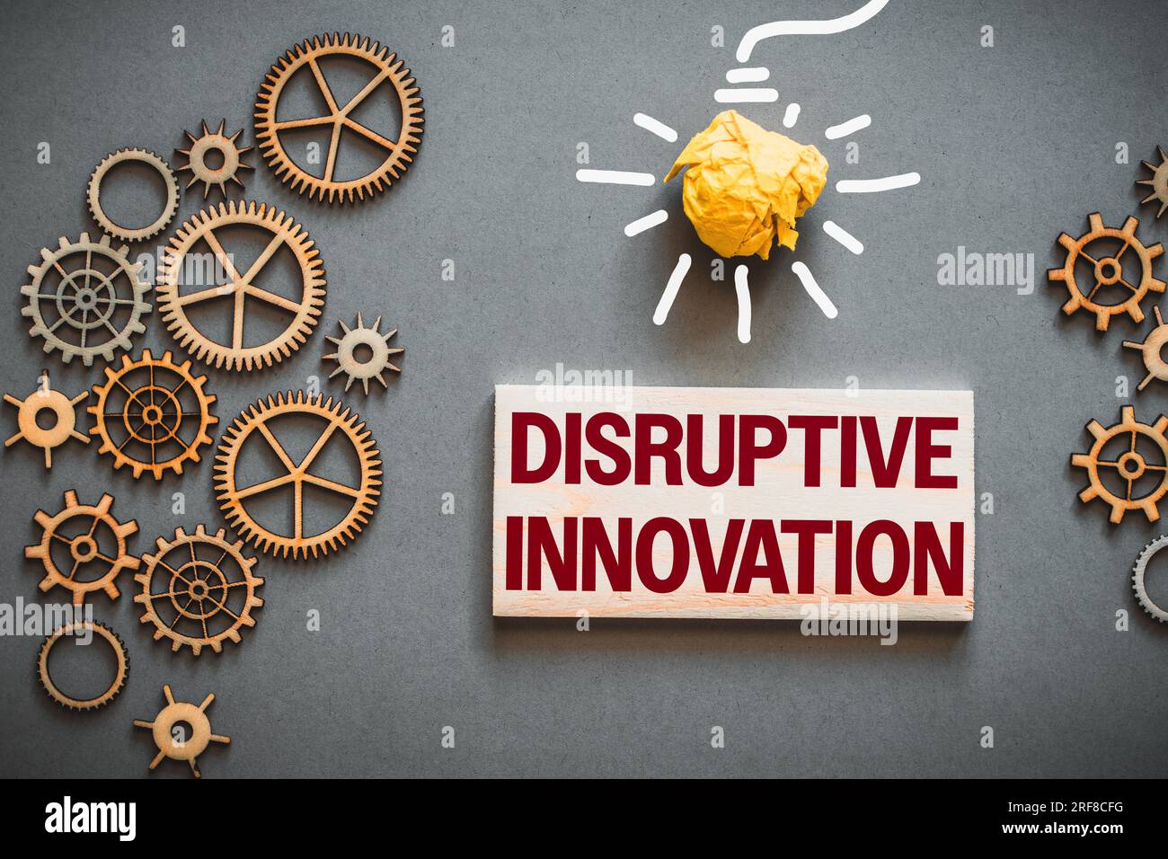 Disruptive innovation text on wooden block. Between gears, precision ...
