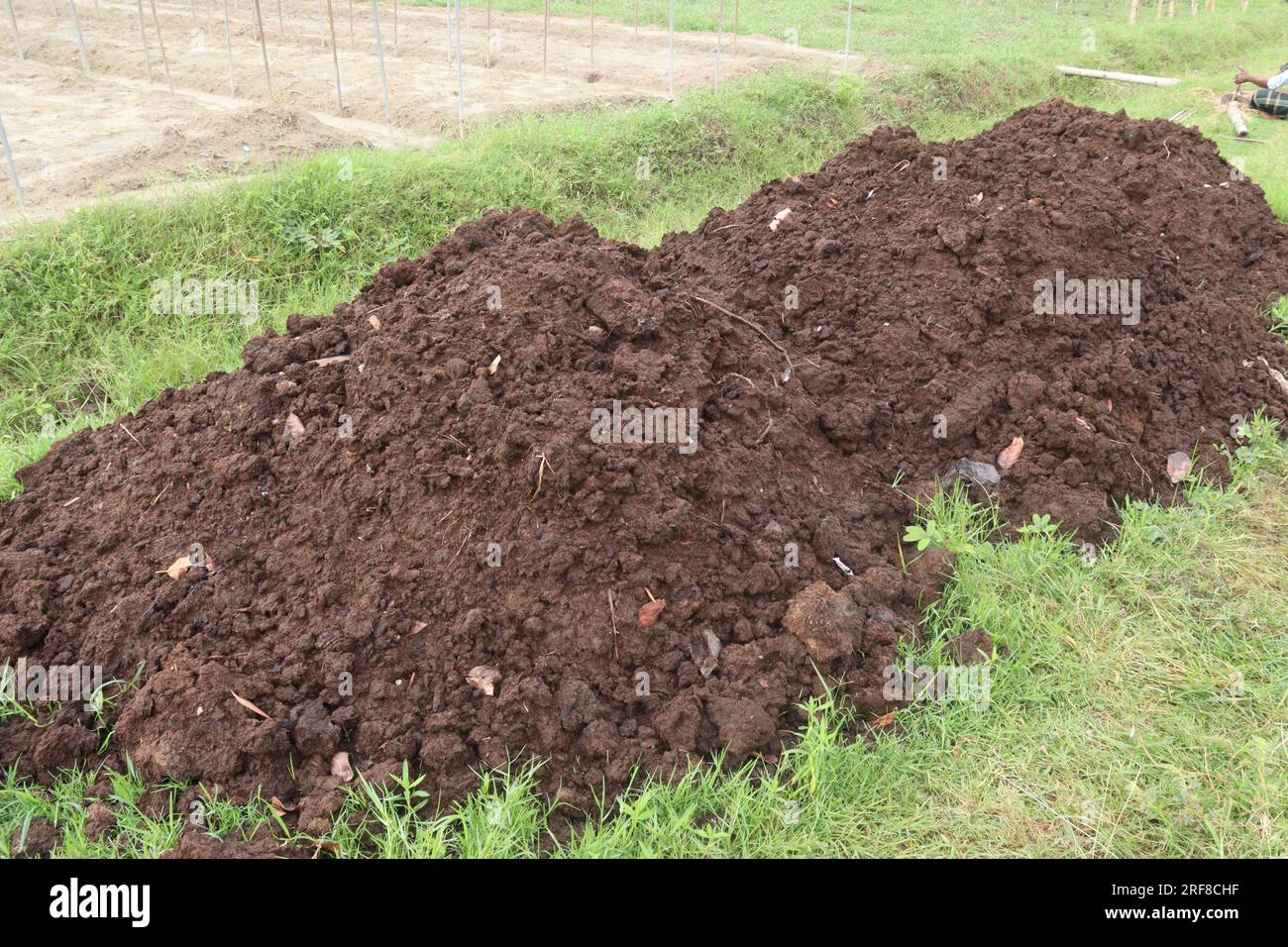 Heap of compost fertilizer on field for crops Stock Photo - Alamy