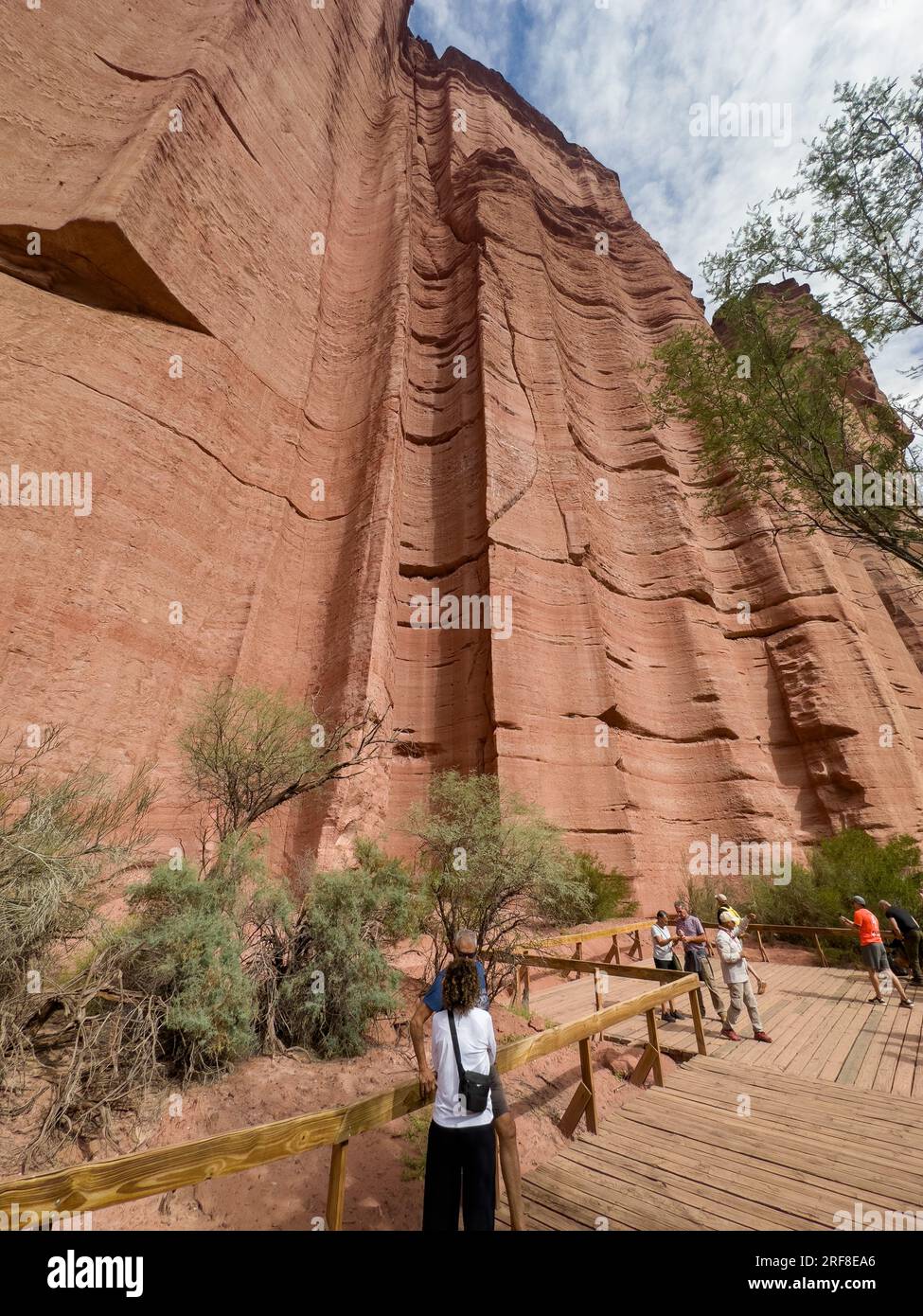 Tourists at the Chimney, an eroded channel in the sandstone wall of the ...