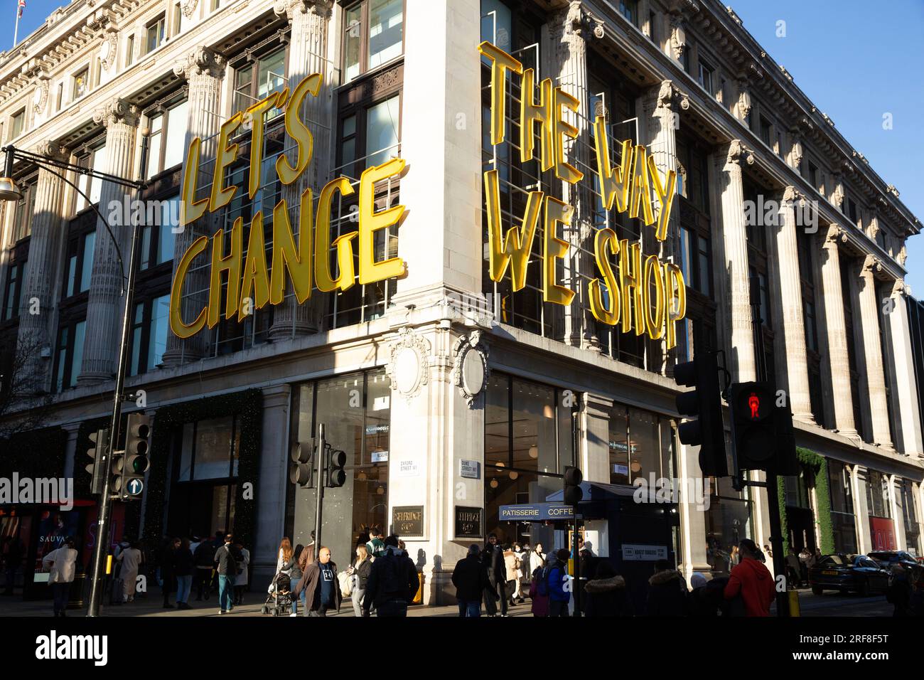 People are silhouetted against Selfridges store on Oxford Street in ...