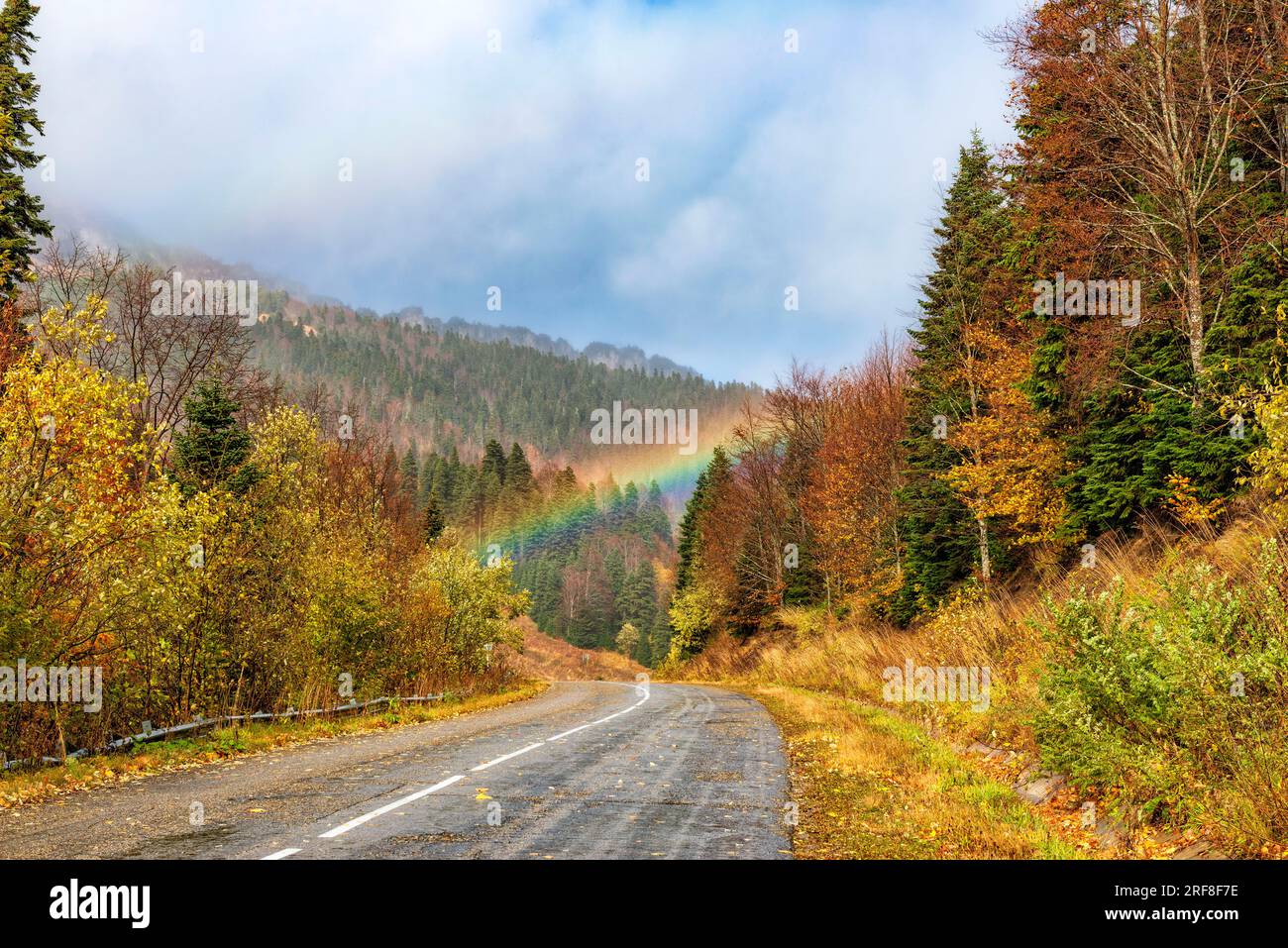 Rainbow over the autumn forest in the mountains of the Republic of ...