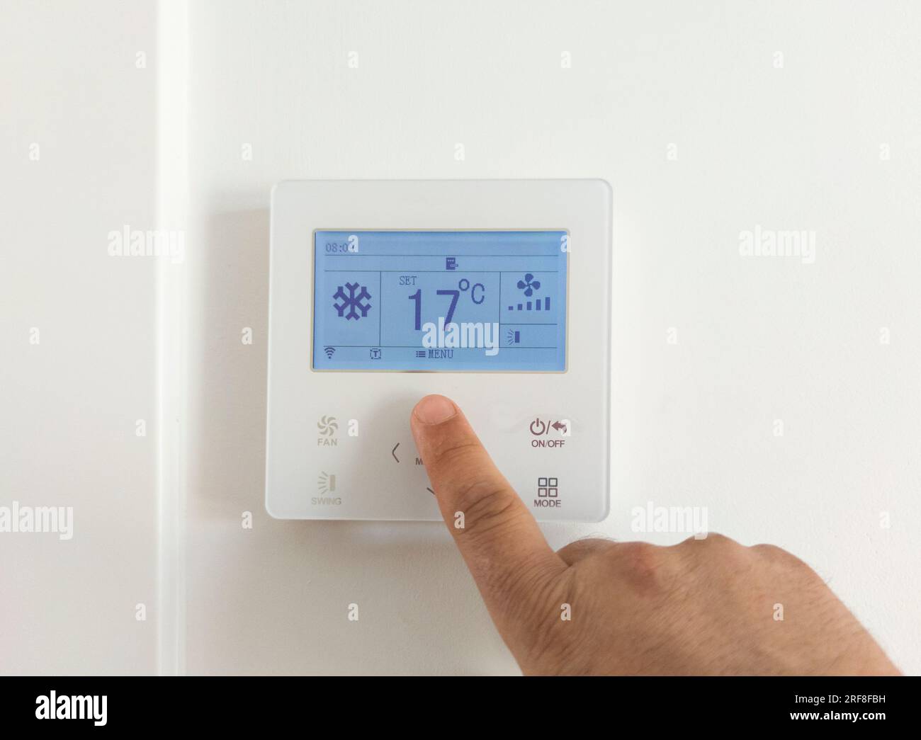 Adjusting room climate control with electronic screen. 17 celsius ...