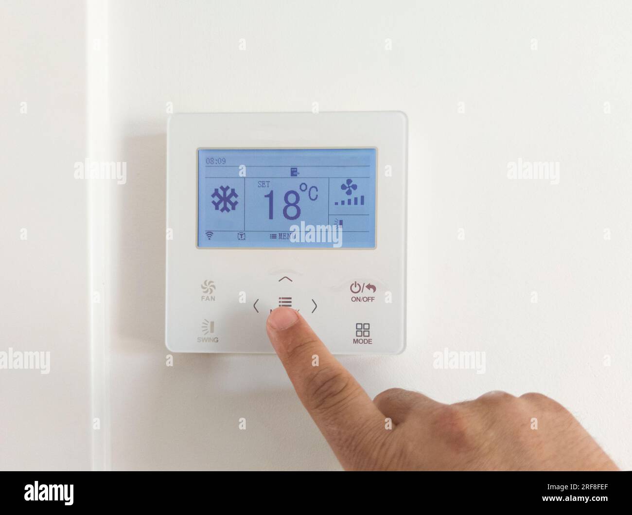 Adjusting room climate control with electronic screen. 18 celsius ...