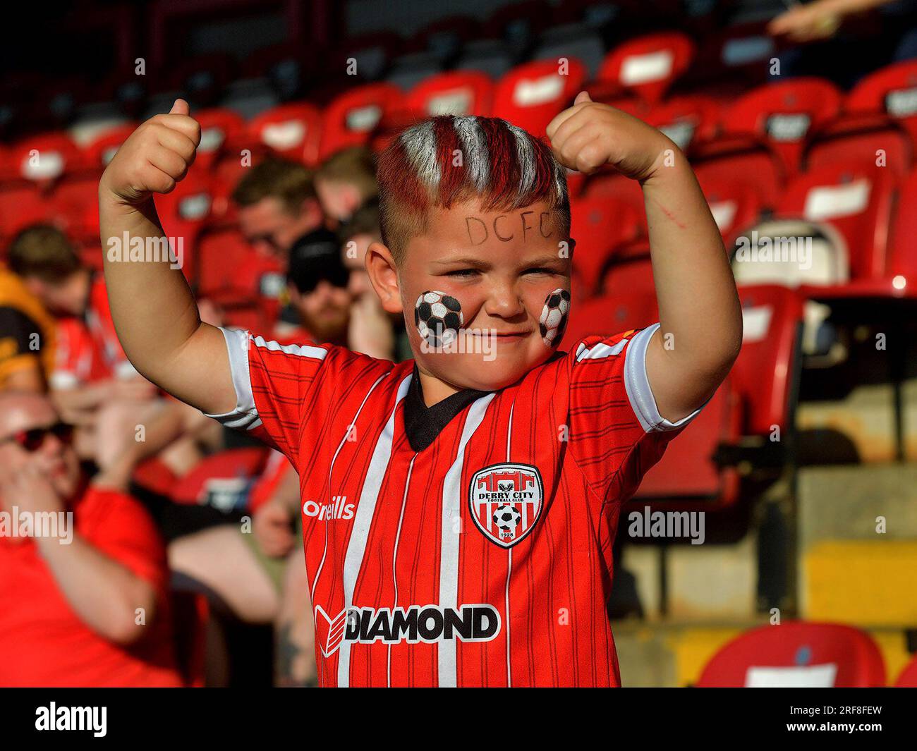 Young fan of League of Ireland football team Derry City with his face ...