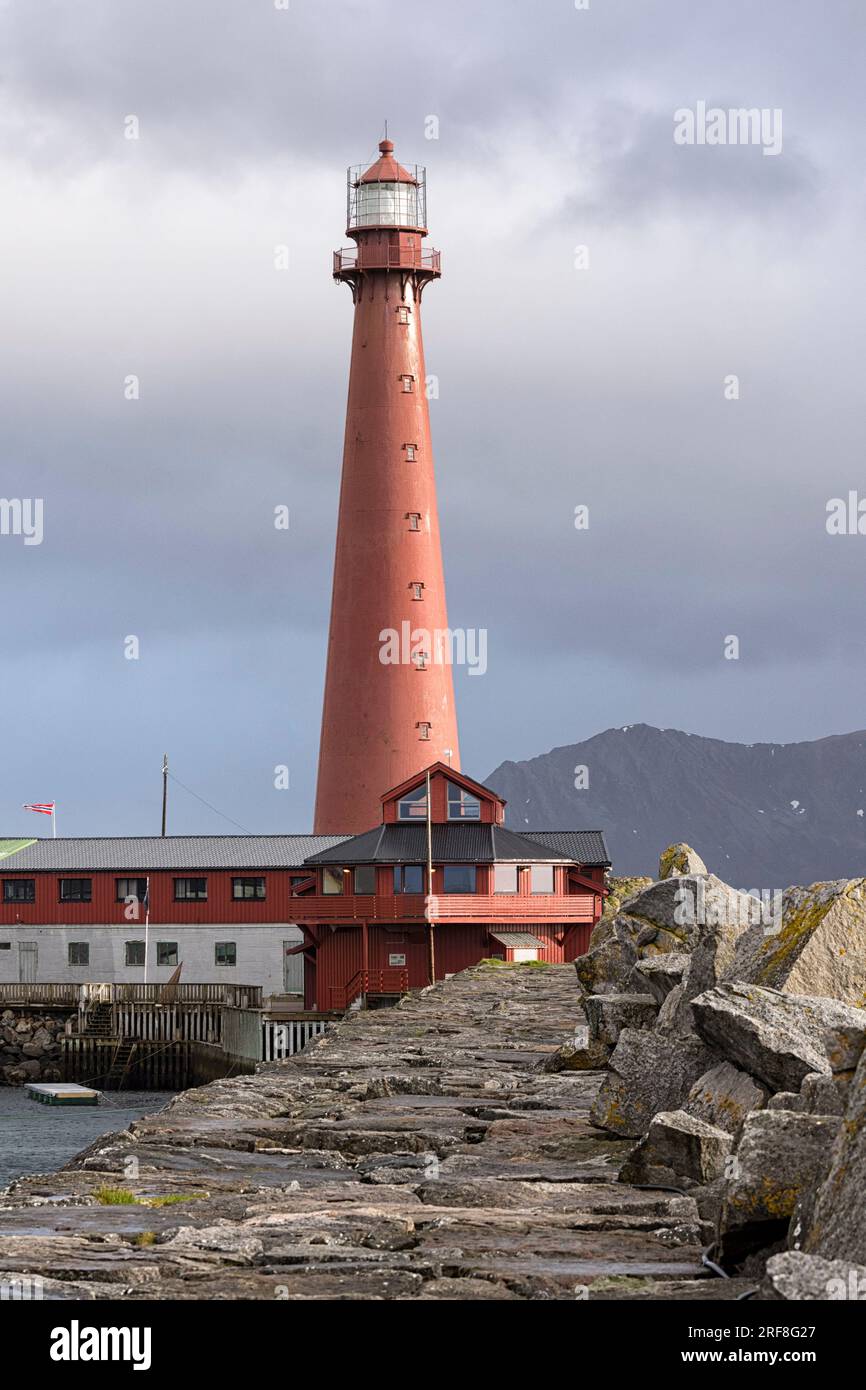 View of the Andenes fyr (lighthouse) from the quay wall against cloudy ...