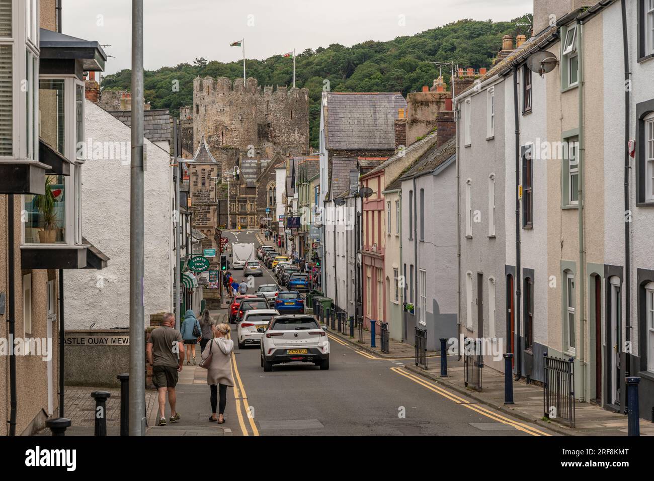 Street in conwy with castle background Stock Photo - Alamy